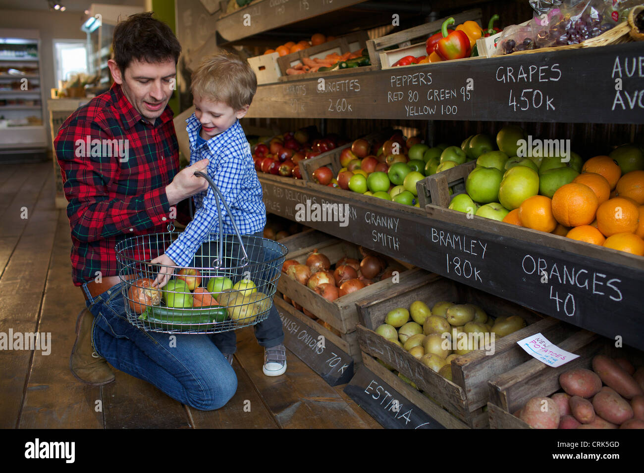Father and son buying produce in store Stock Photo - Alamy