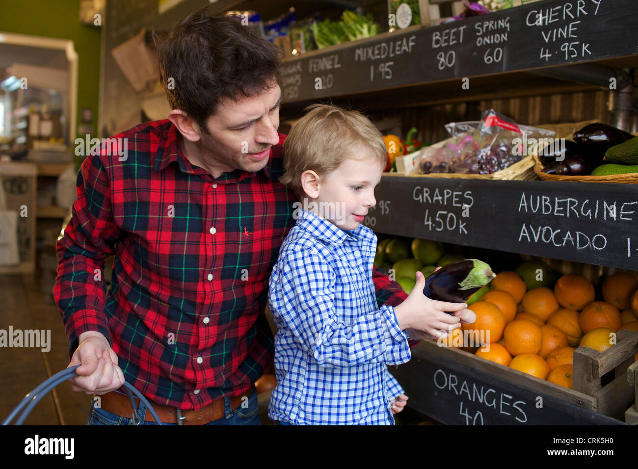 Father and son buying produce in store Stock Photo - Alamy