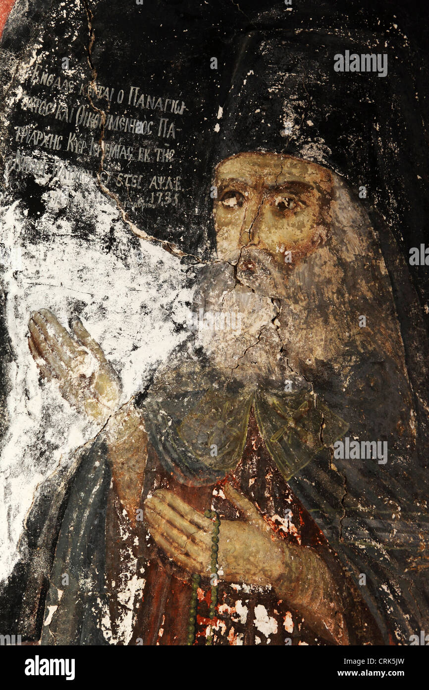 Peeling fresco of an Orthodox saint on a wall at the Great Lavra ...