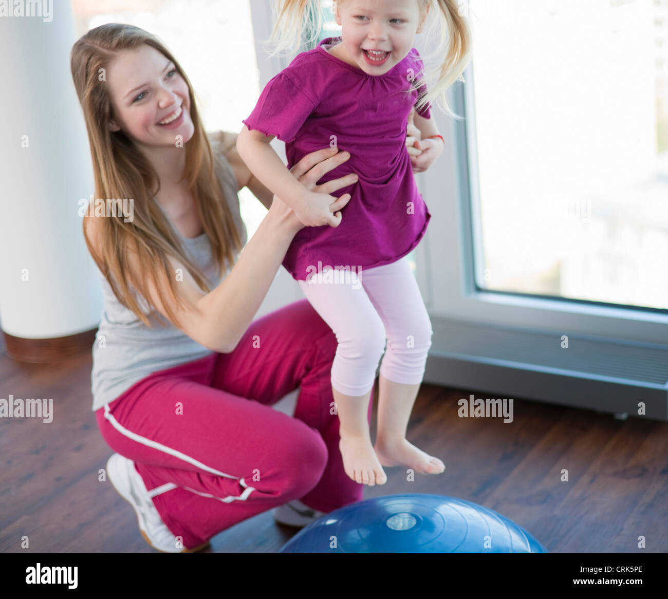 Girls playing with exercise ball in gym Stock Photo - Alamy