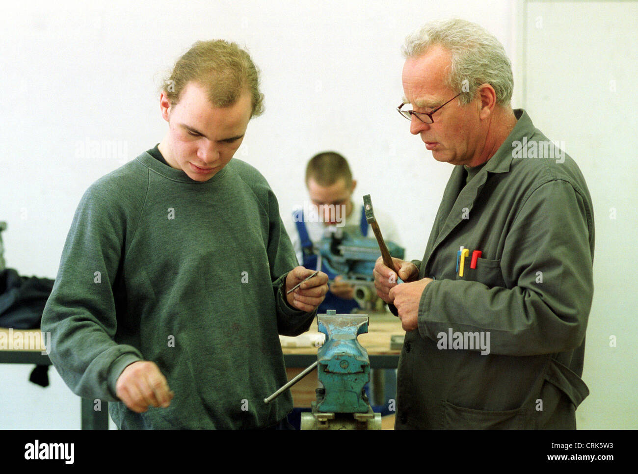 Berlin, an apprentice metal worker is instructed by his master Stock ...