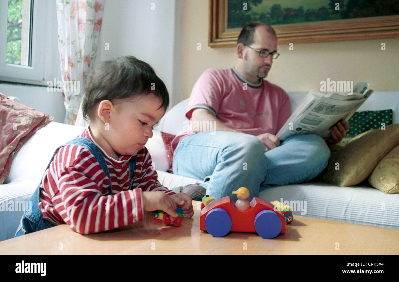 father-reads-while-child-plays-stock-photo-alamy