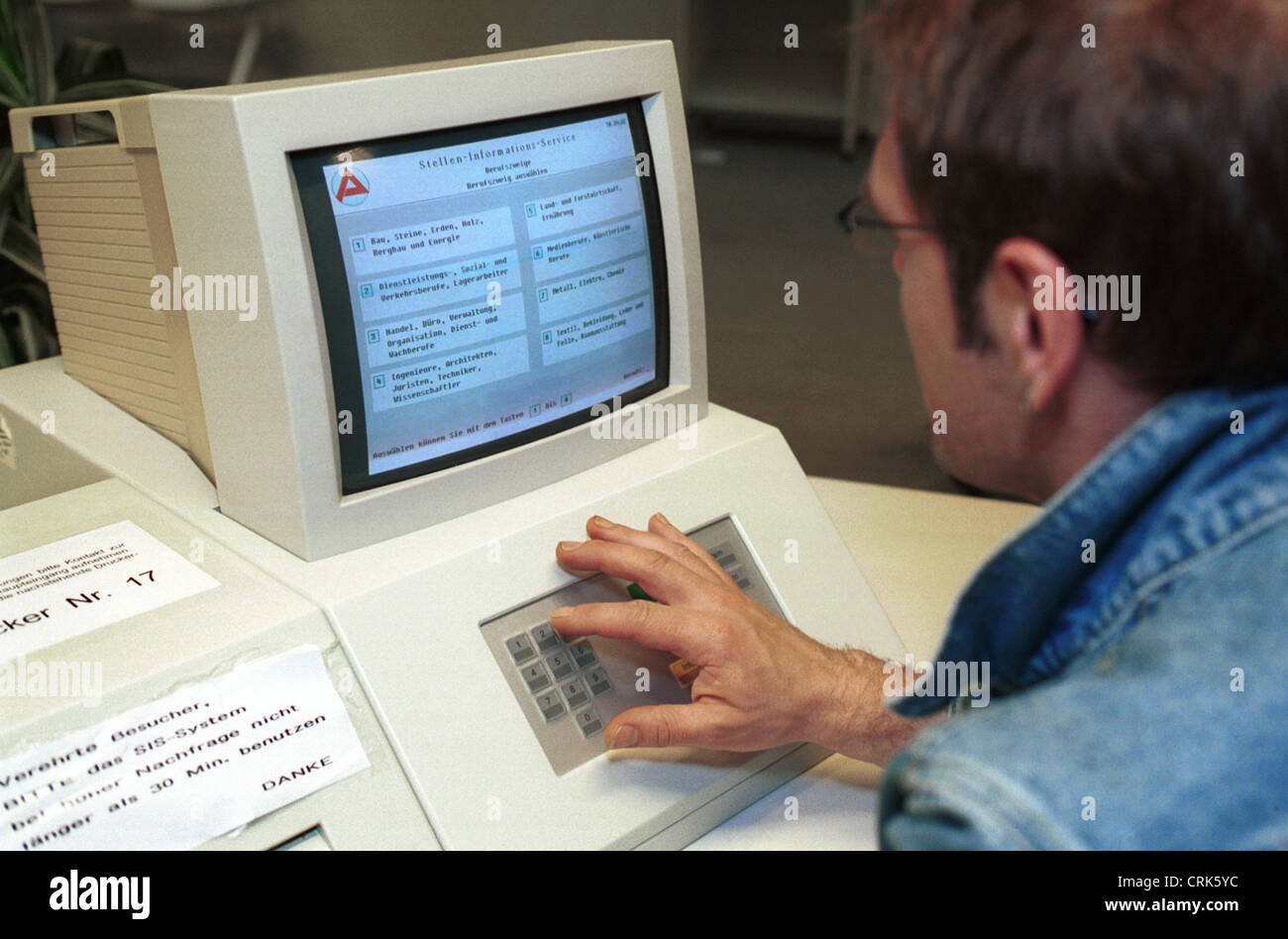 Man in office working on computer Stock Photo - Alamy