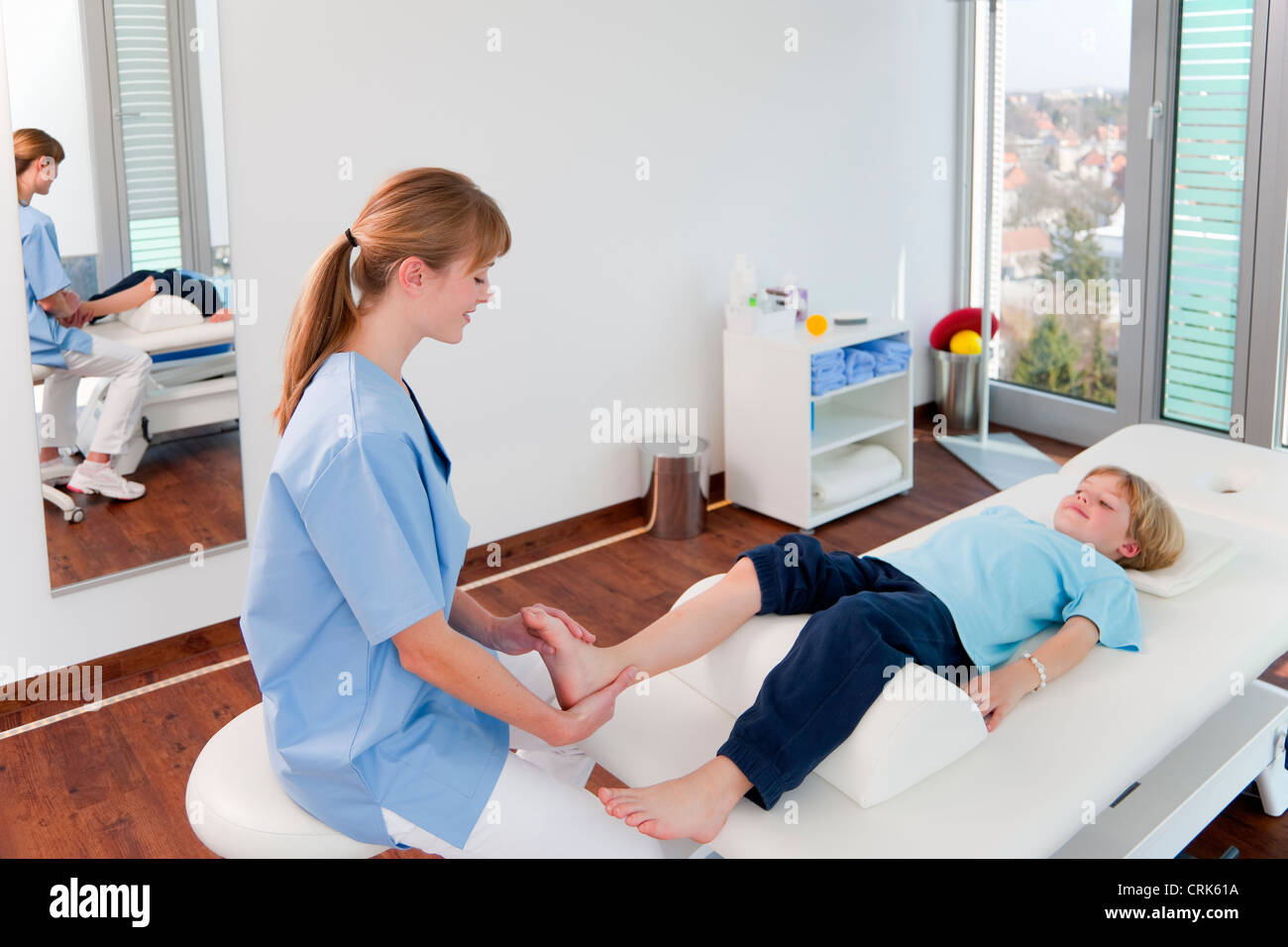 Doctor examining boys feet in office Stock Photo - Alamy