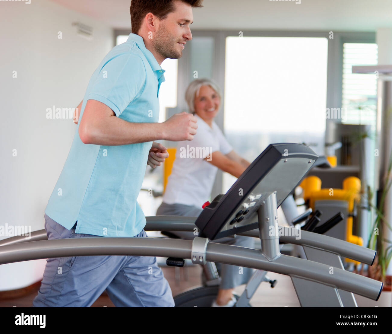 Man using treadmill in gym Stock Photo - Alamy