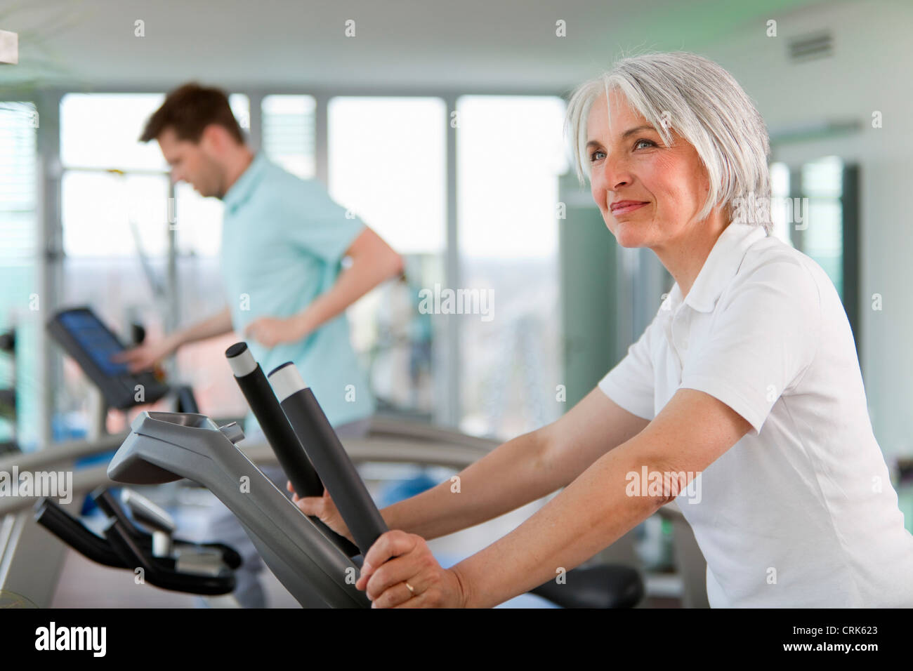Older woman using treadmill in gym Stock Photo - Alamy
