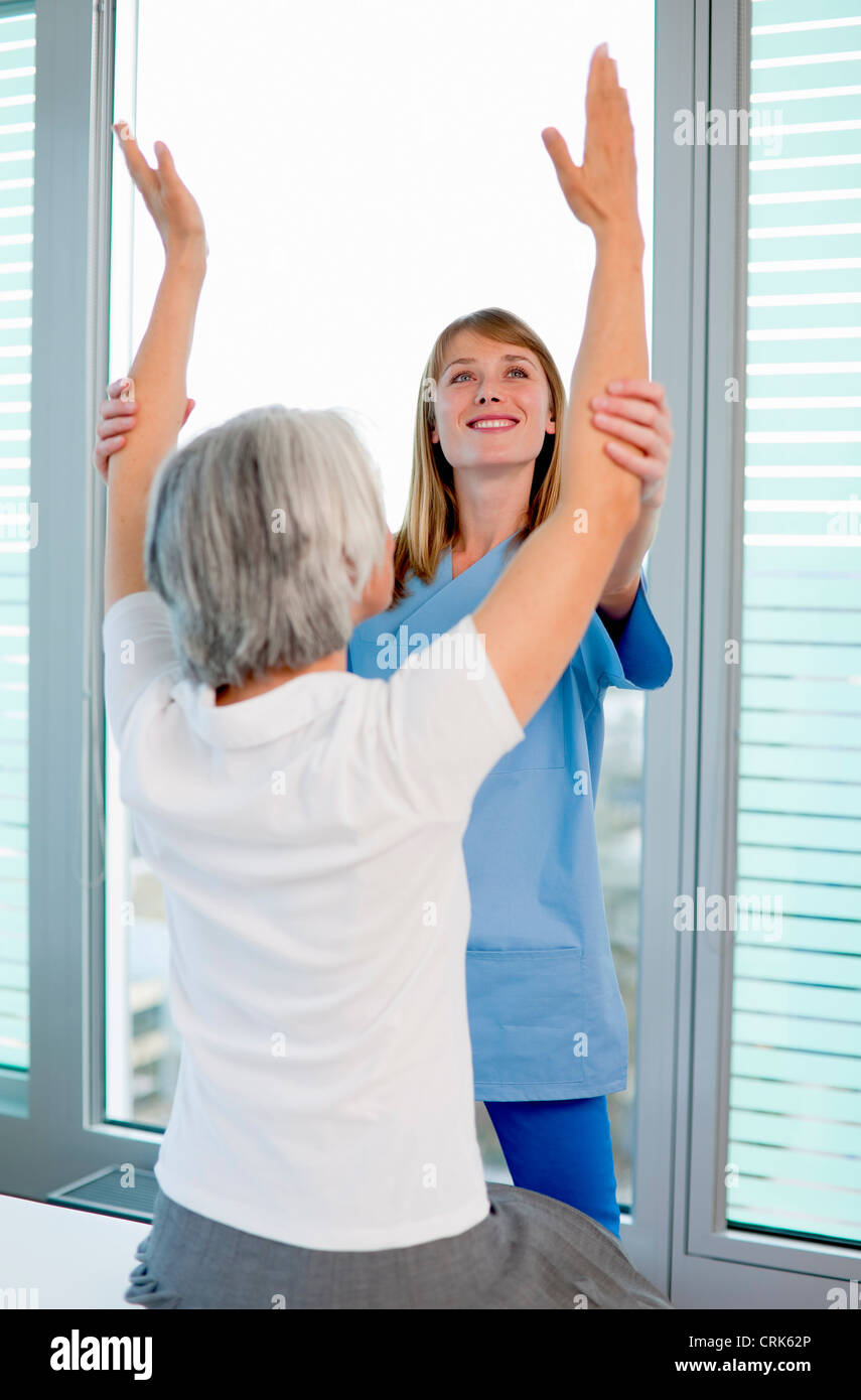 Physiotherapist examining womans arm hi-res stock photography and ...