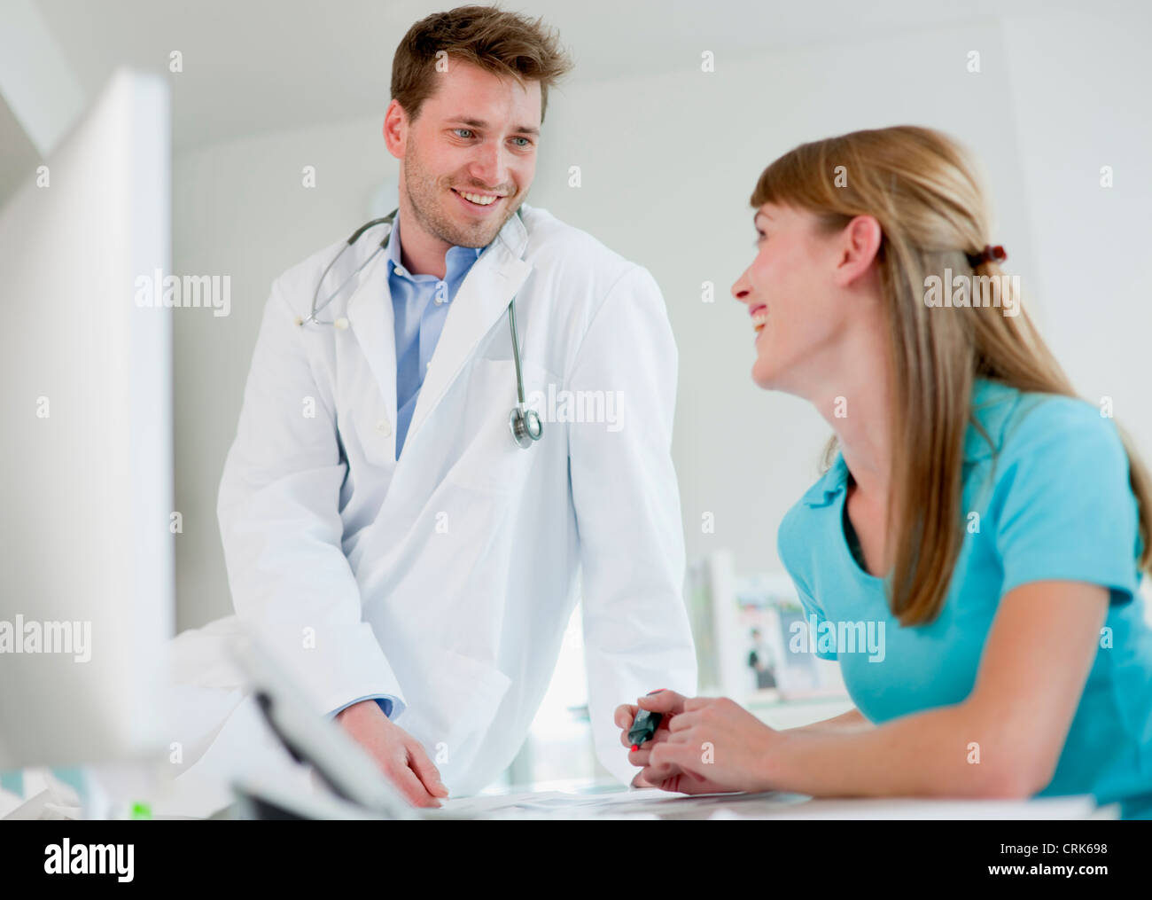 Doctor talking to receptionist in office Stock Photo - Alamy
