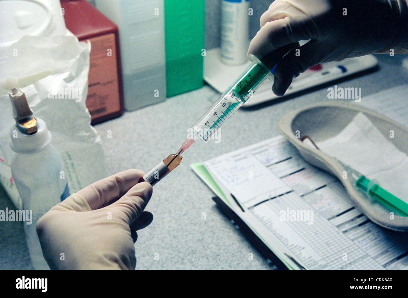 Filling of a disposable syringe with a vitamin solution Stock Photo - Alamy