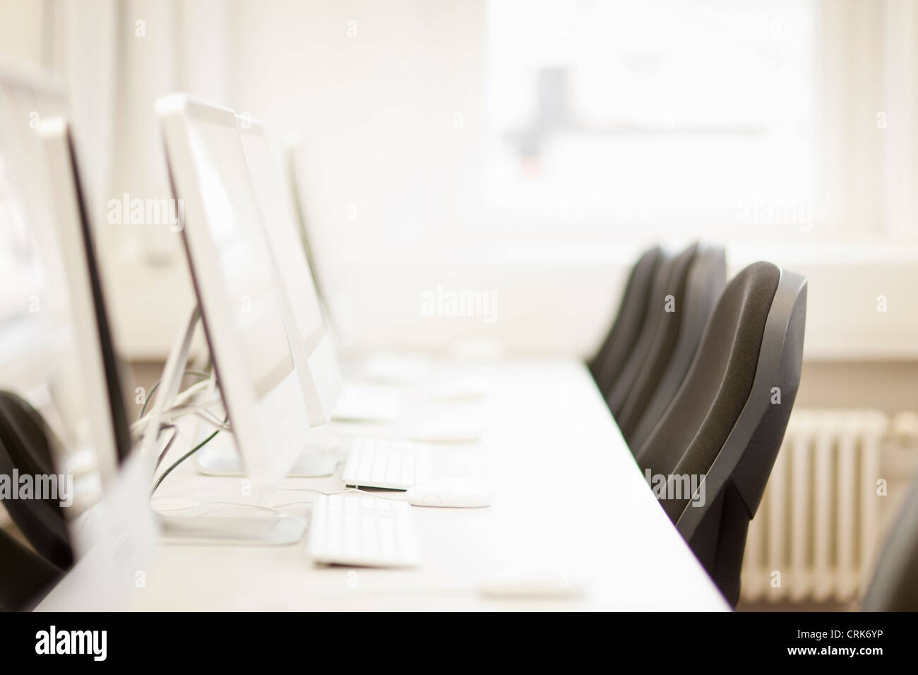 Empty computer desks in office Stock Photo - Alamy