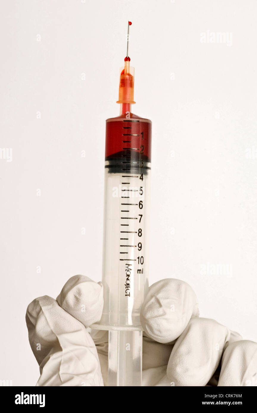 View of a needle attached to a syringe, the tip of the needle contains ...
