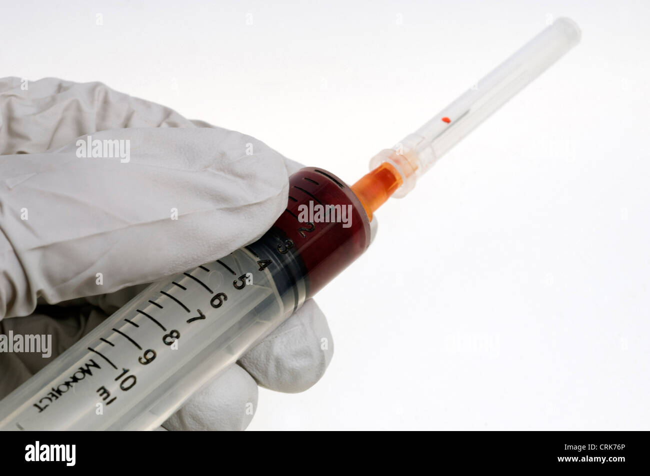 View of a needle attached to a syringe, the tip of the needle contains ...