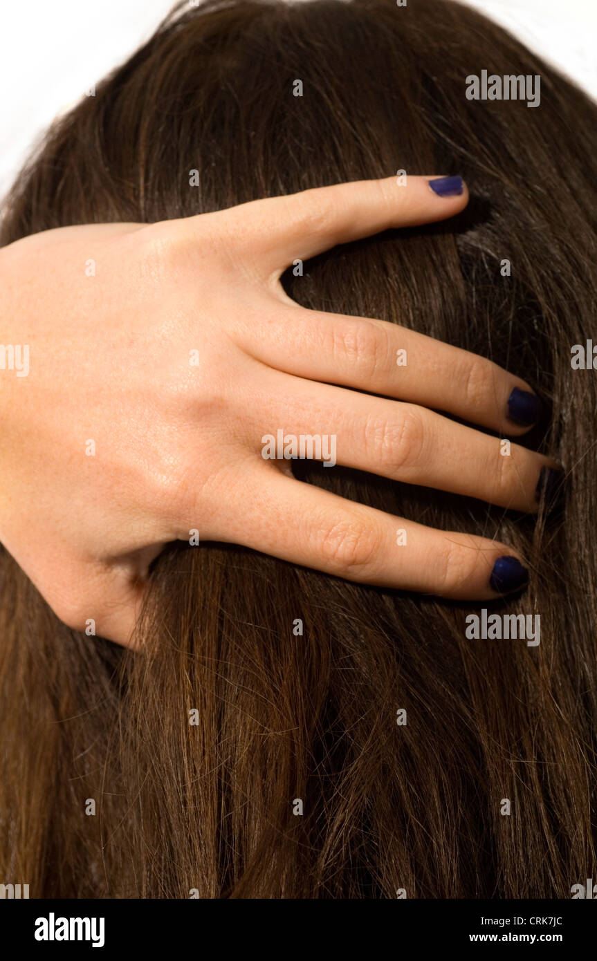 Young woman runs her hands through her hair Stock Photo - Alamy