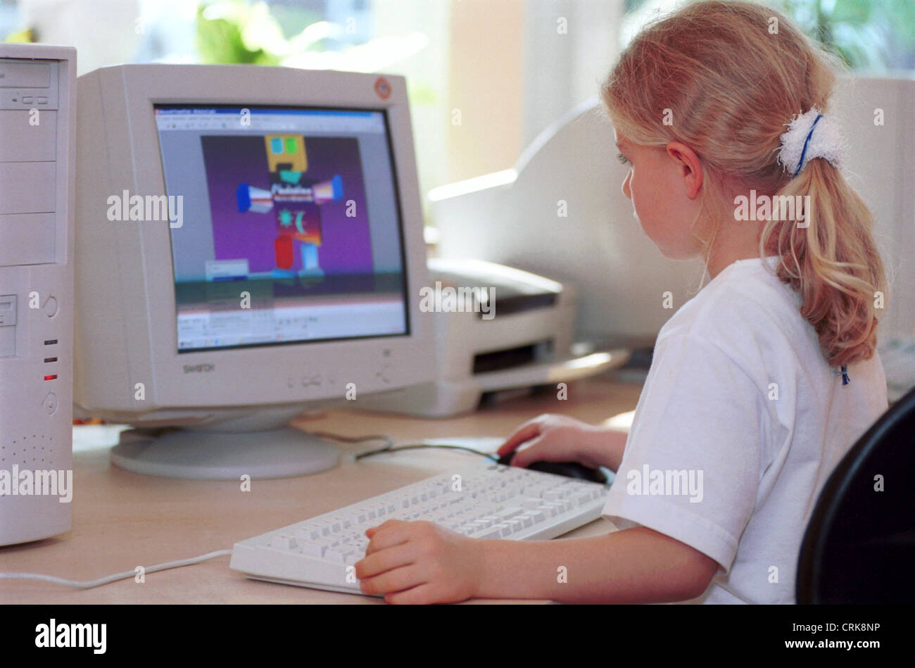 Girl on computer Stock Photo - Alamy
