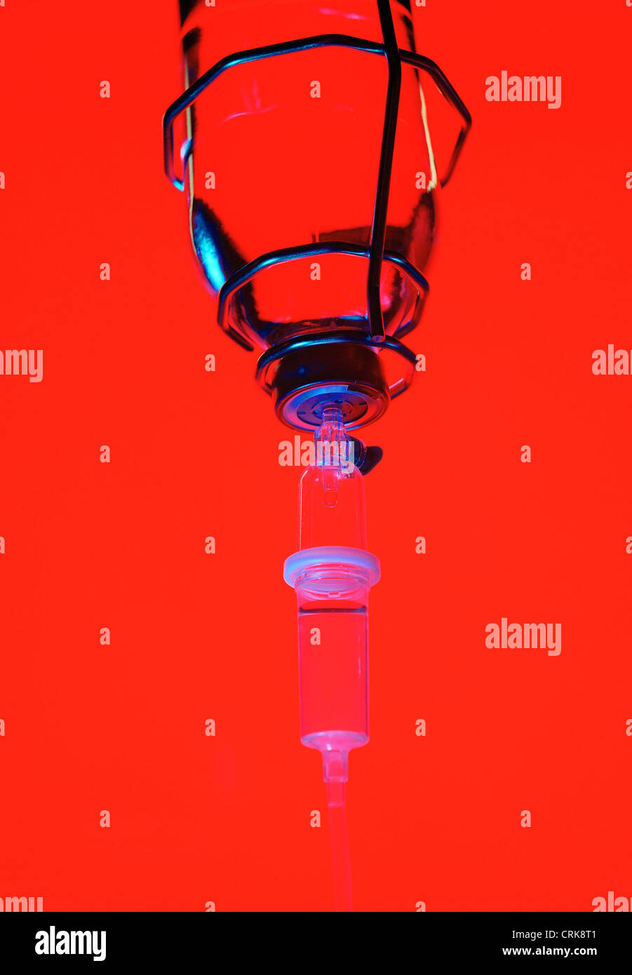 Infusion bottle in silhouette against a red background Stock Photo - Alamy