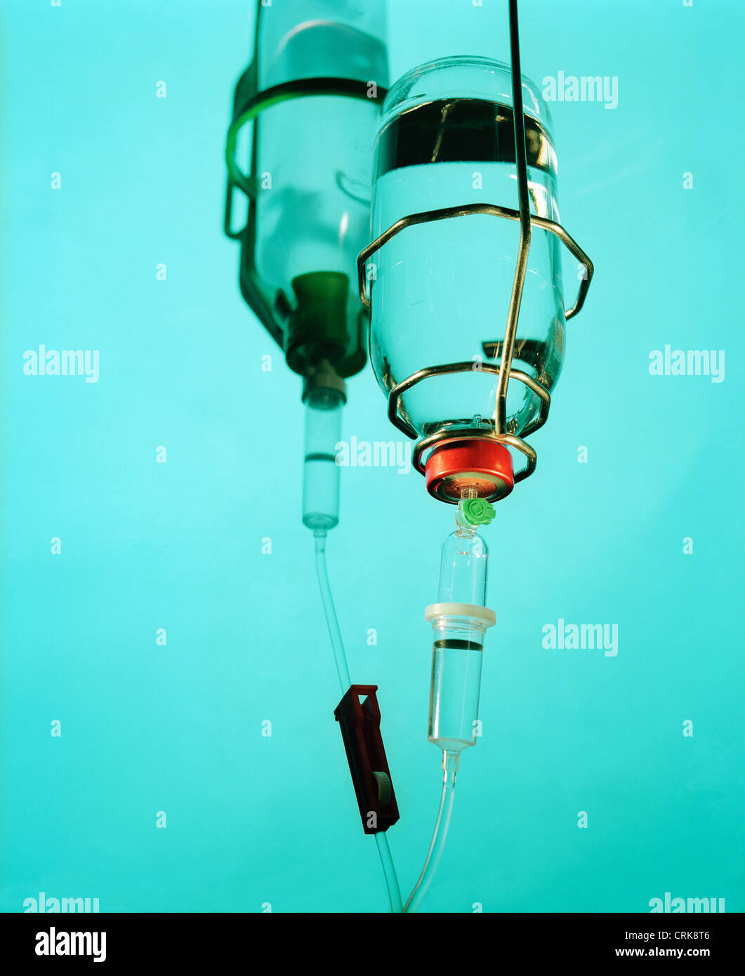 Two full infusion bottles on a colored background Stock Photo - Alamy