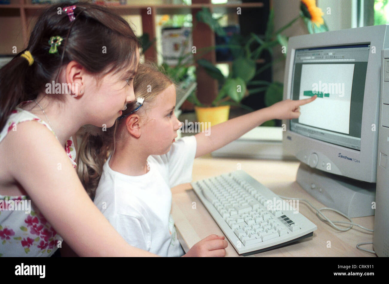 Girl on computer Stock Photo - Alamy