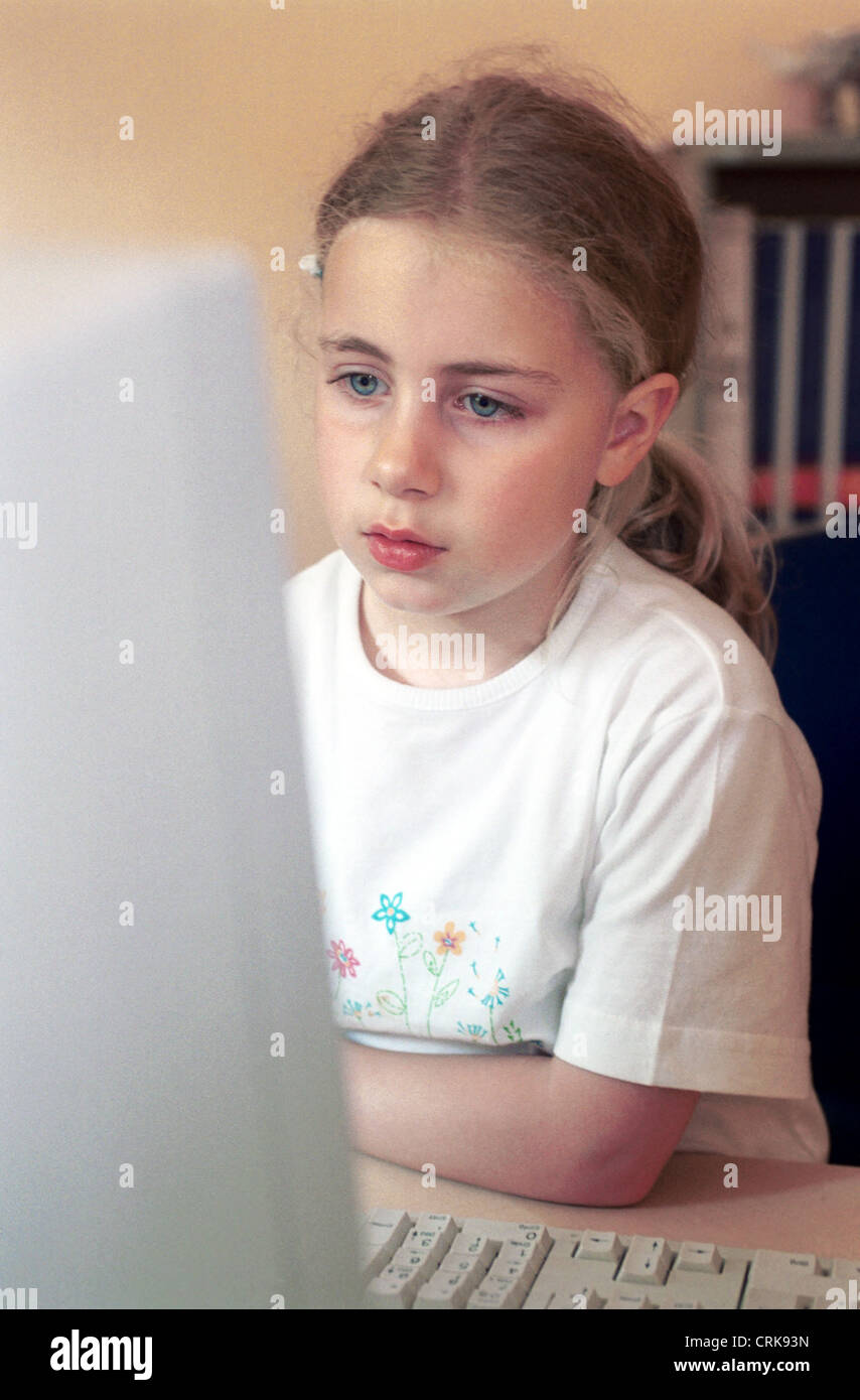 Girl on computer Stock Photo - Alamy