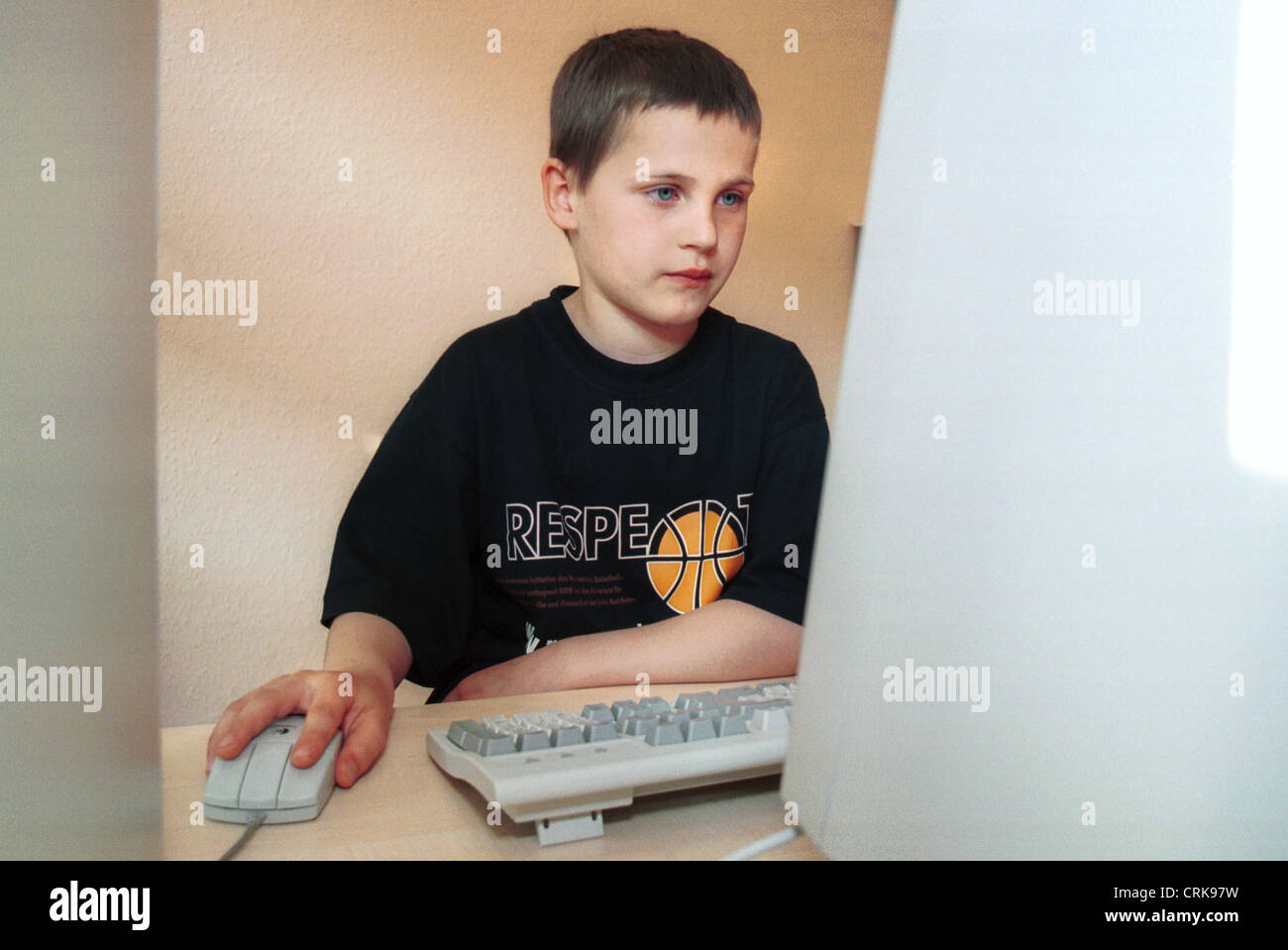 Boy on computer Stock Photo - Alamy