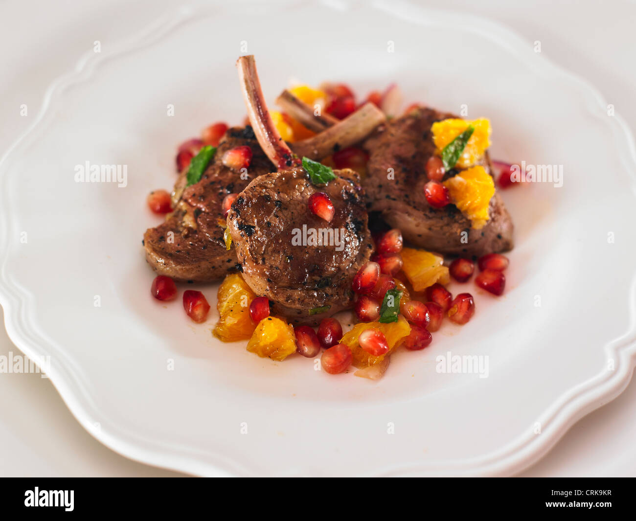 lamb chops from rack with mint pomegranate and orange Stock Photo - Alamy