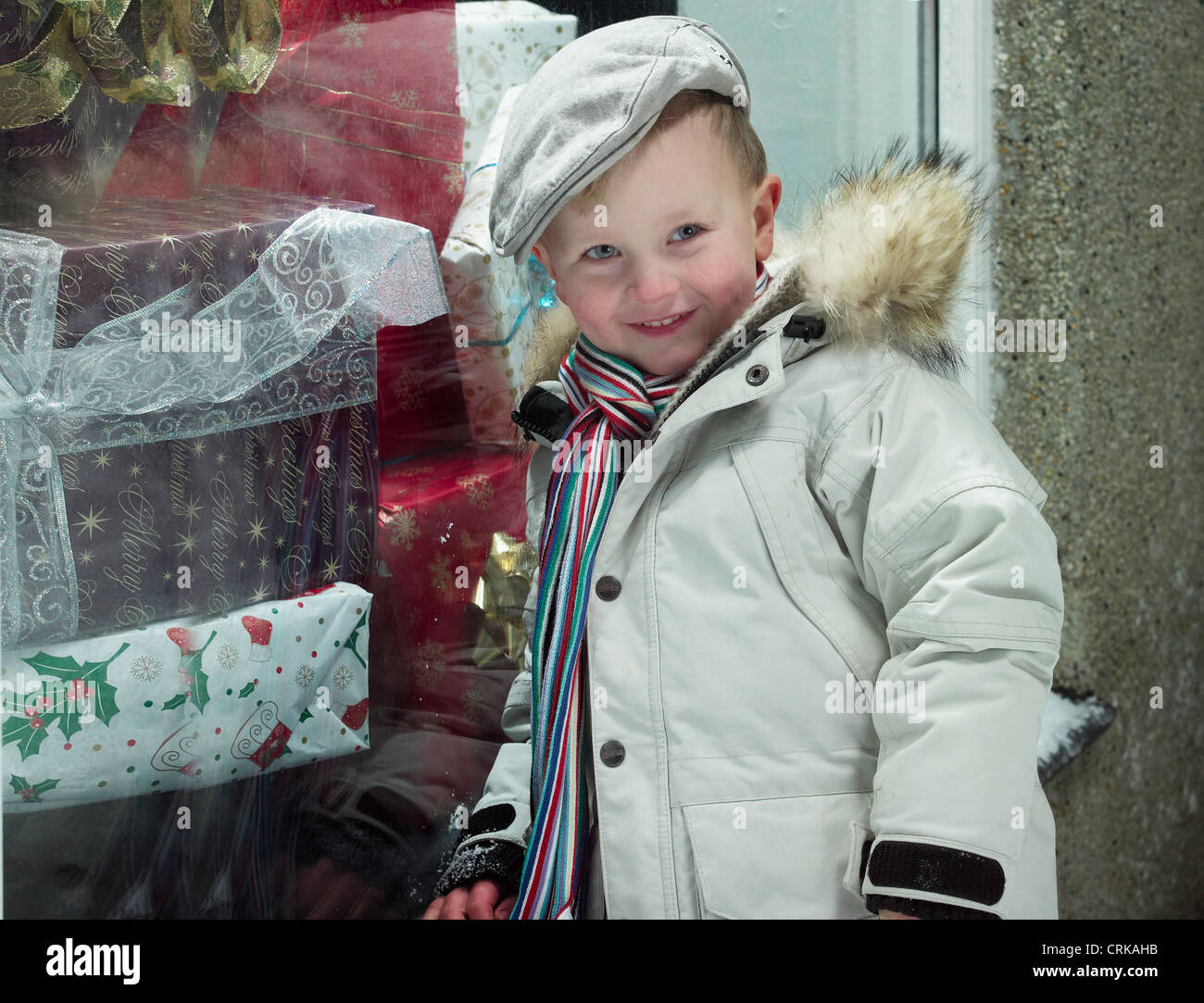 Smiling boy standing in snow Stock Photo - Alamy