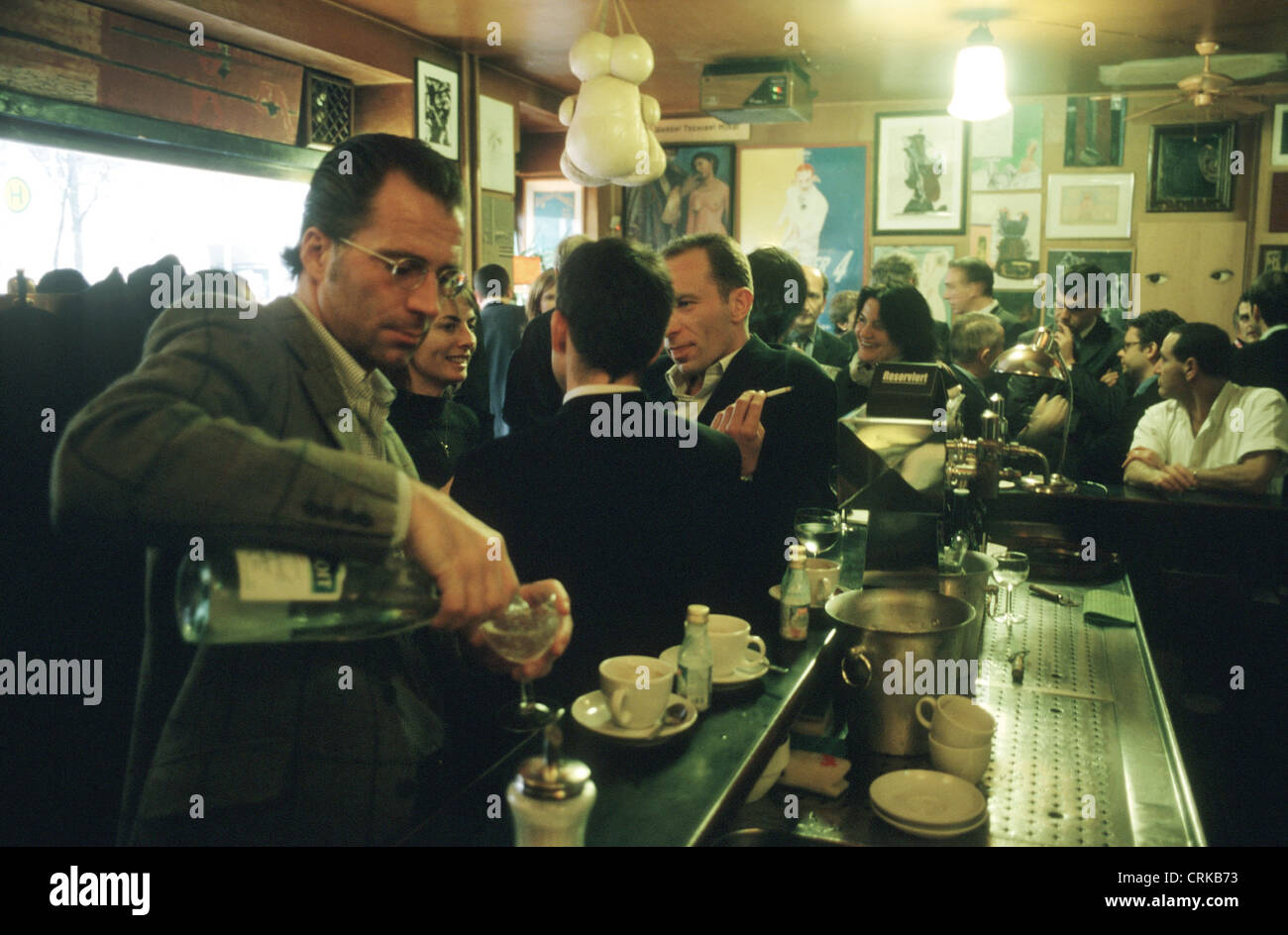 Guests talk at the Paris Bar Stock Photo - Alamy