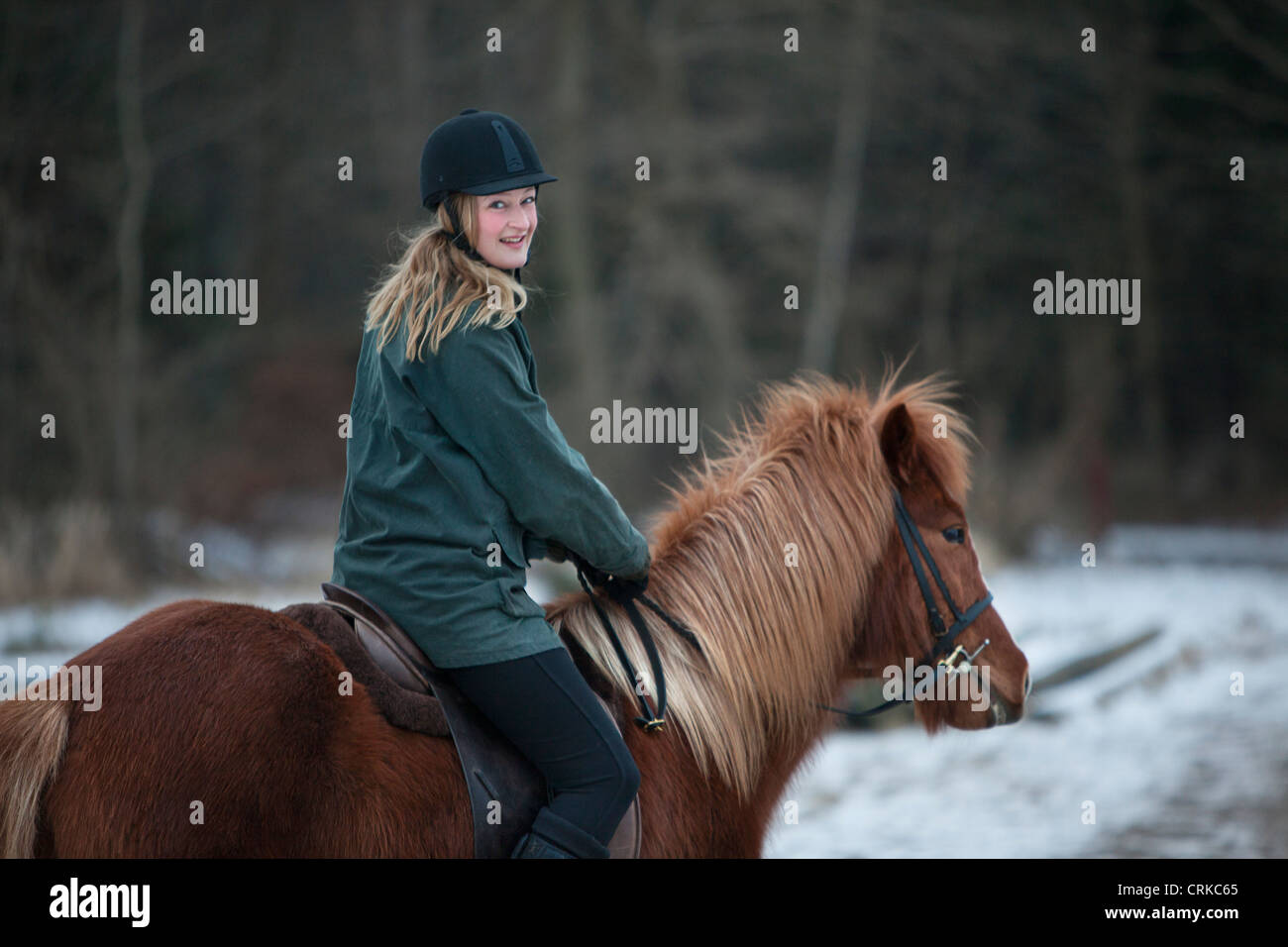 Woman riding horse in snow Stock Photo - Alamy