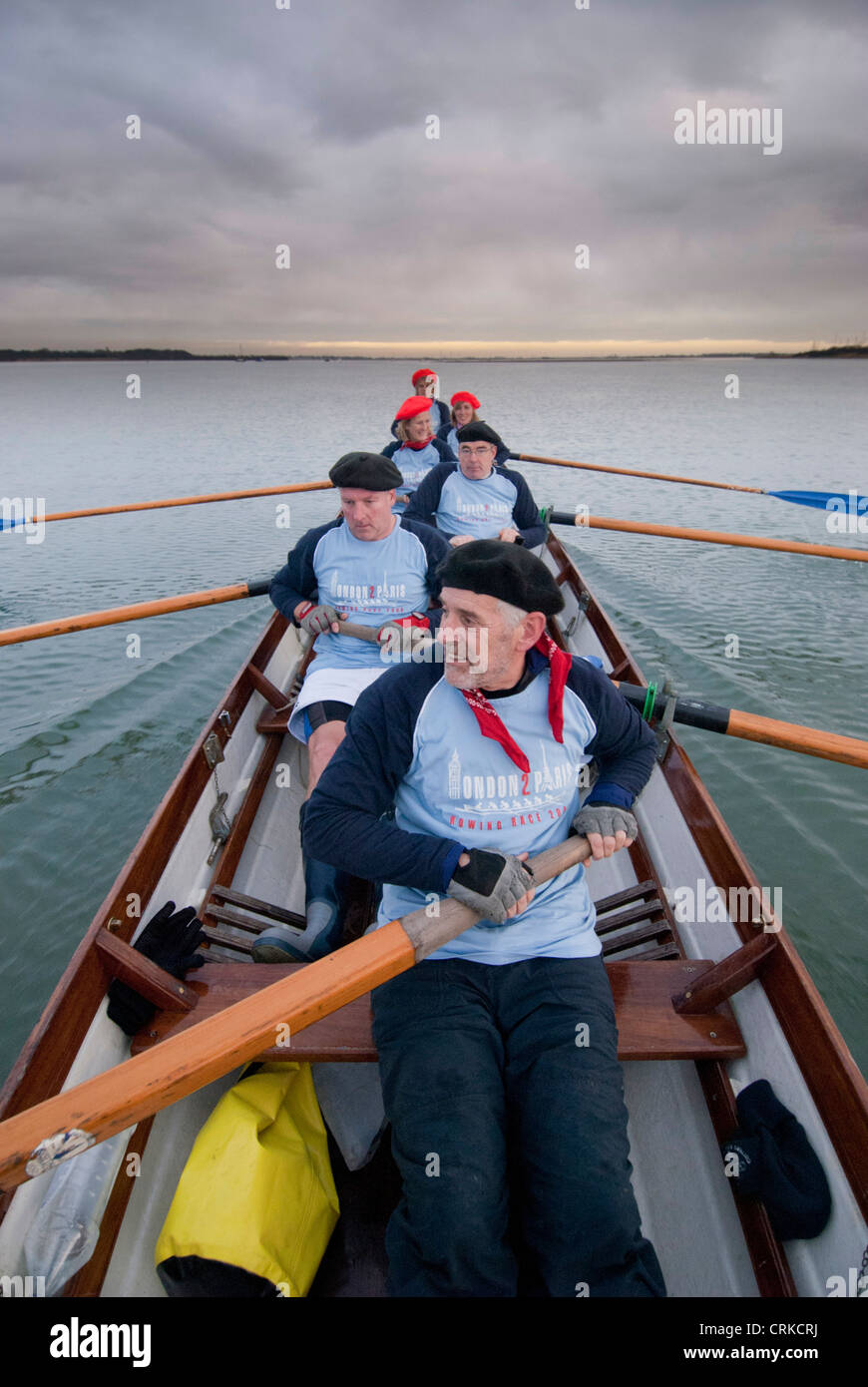 Rowing crew aboard a skiff in Langstone Harbour, near Hayling Island ...