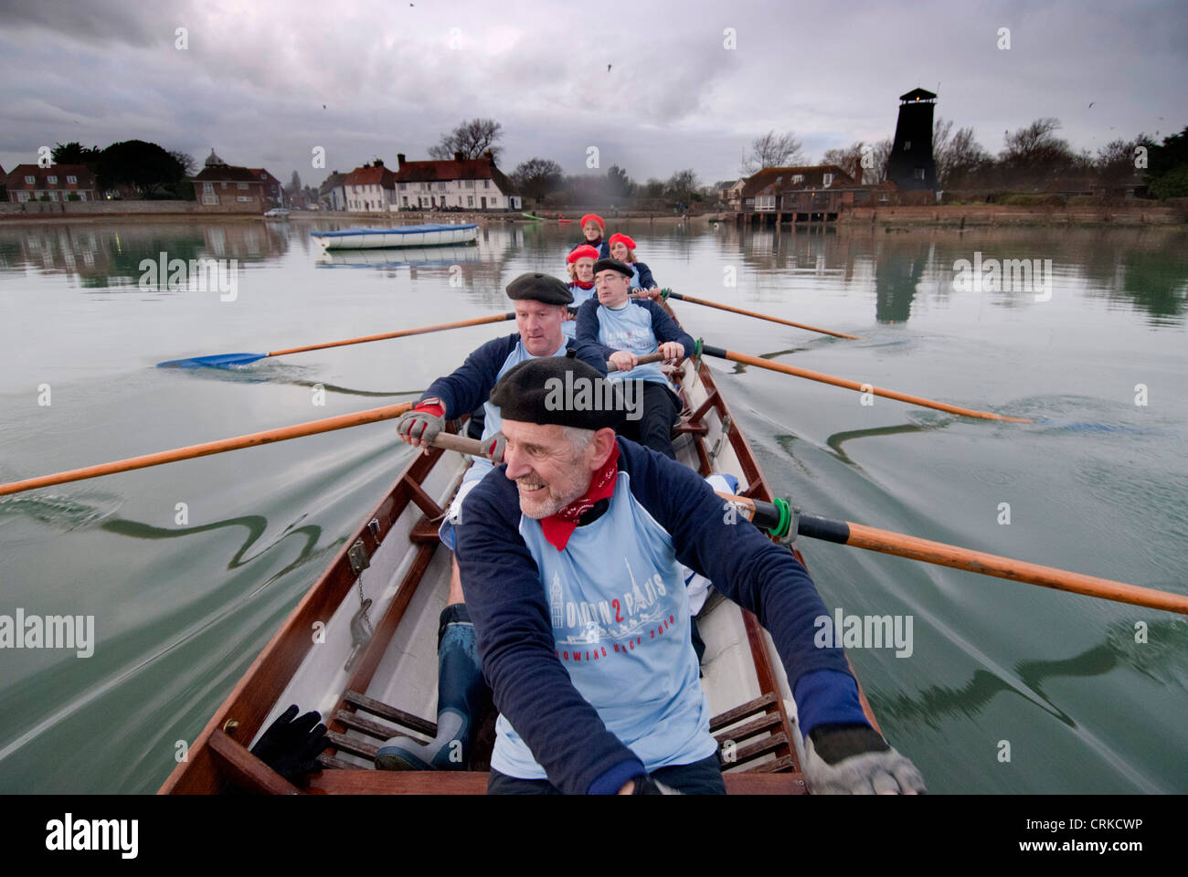 Rowing crew aboard a skiff in Langstone Harbour, near Hayling Island ...