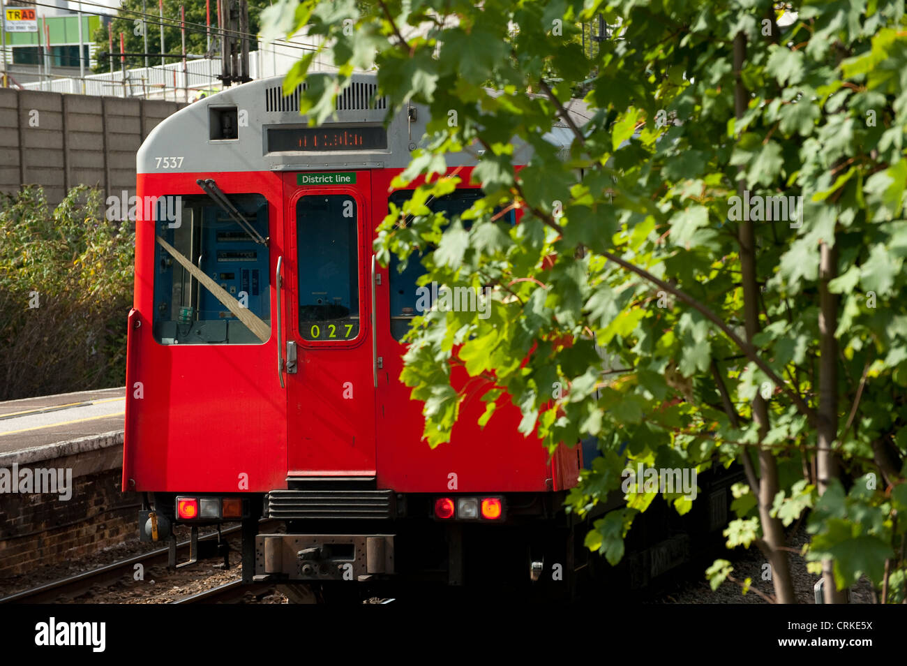 A London Underground train on the district line approaching a railway ...