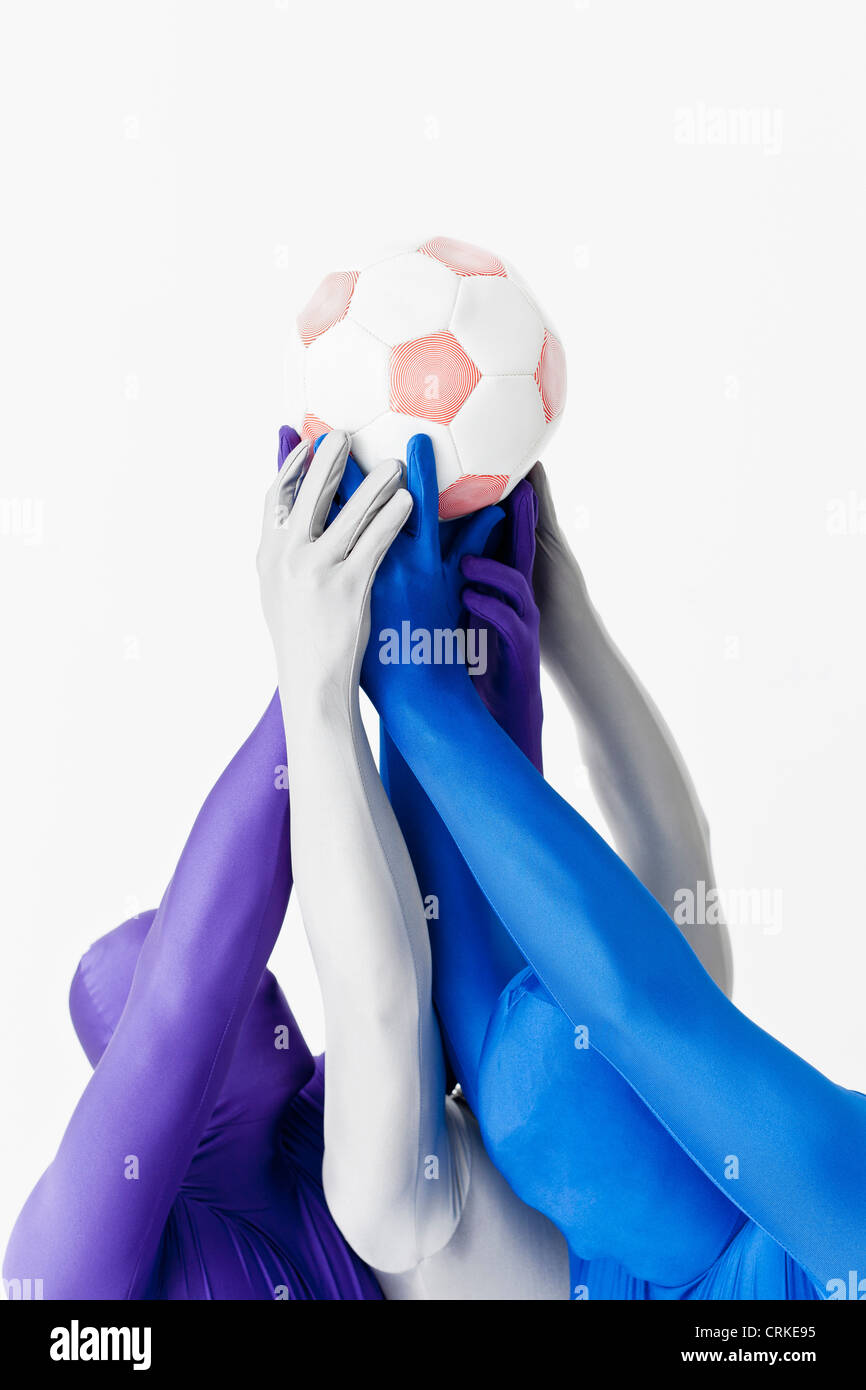 Men in bodysuits holding soccer ball Stock Photo - Alamy