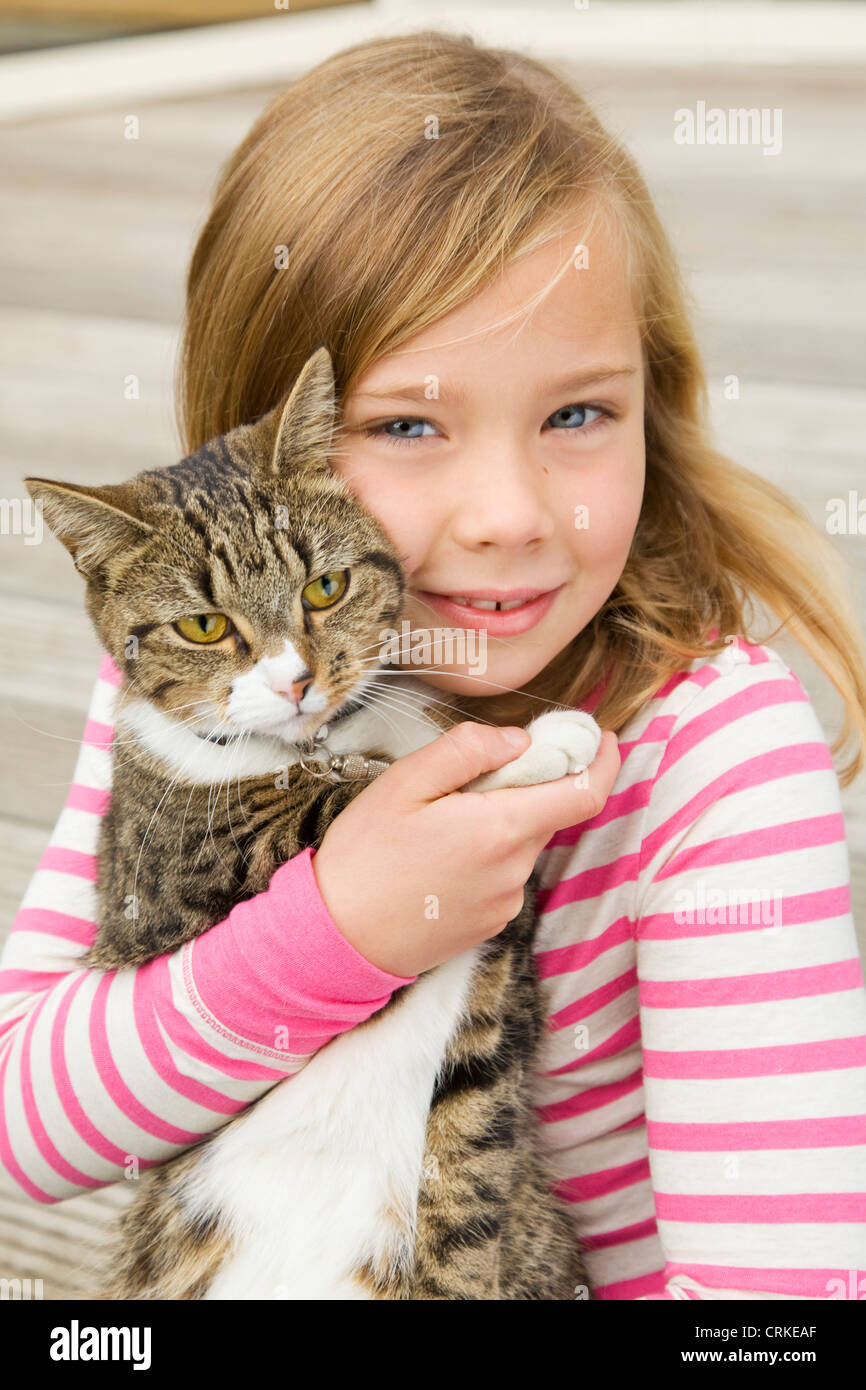 Smiling girl holding cat outdoors Stock Photo - Alamy