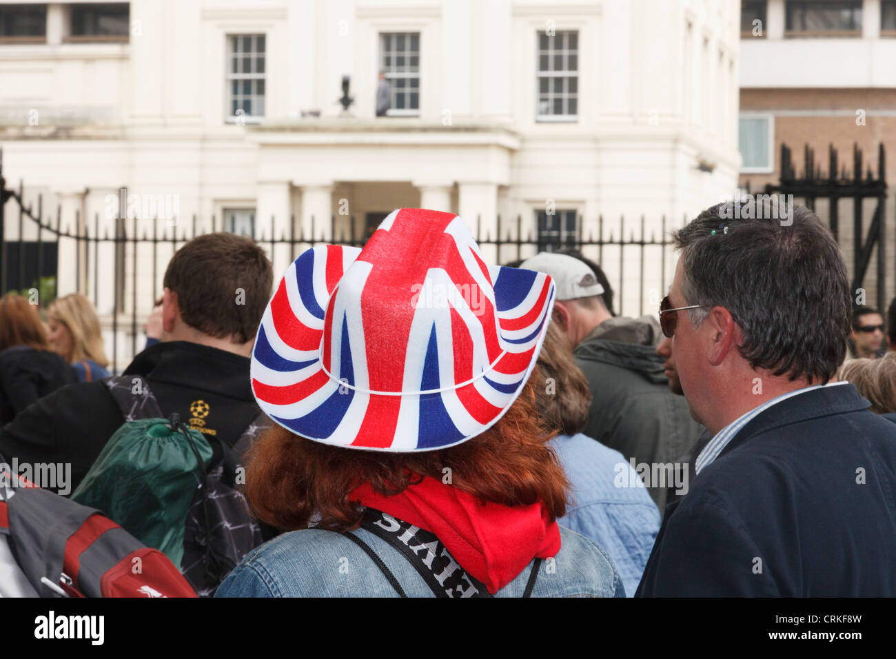 Street scene with a woman wearing a union jack hat in a crowd of people ...