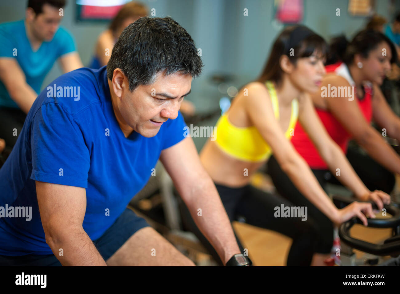 People using spin machines in gym Stock Photo - Alamy