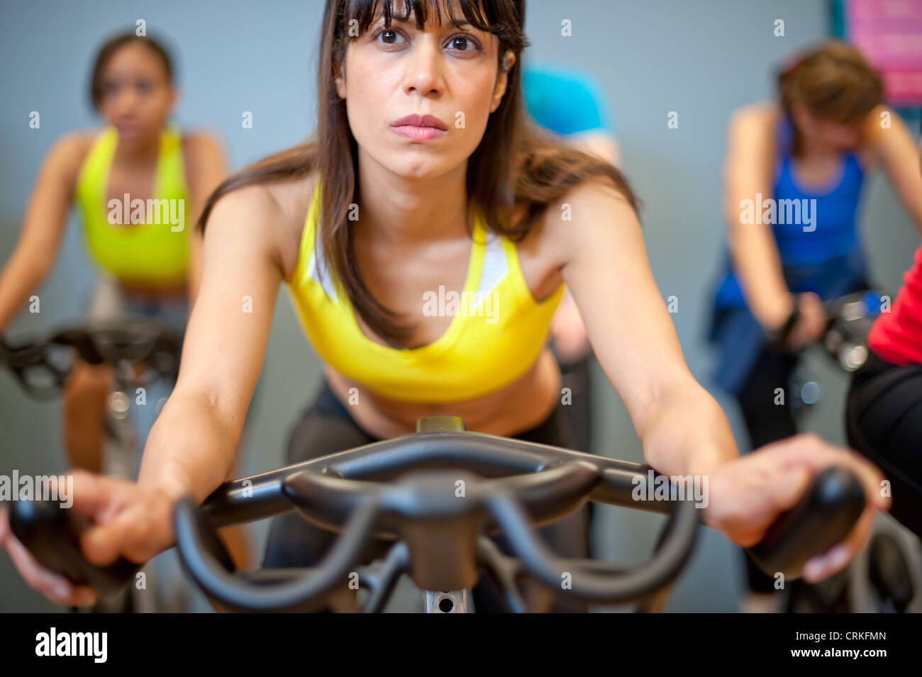 People using spin machines in gym Stock Photo - Alamy