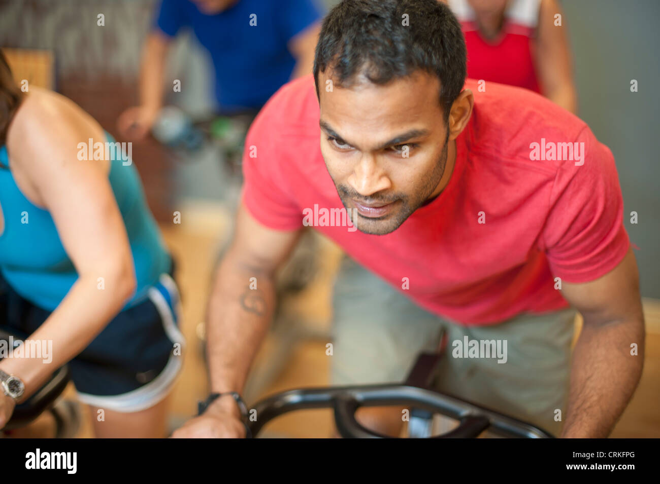 People using spin machines in gym Stock Photo - Alamy