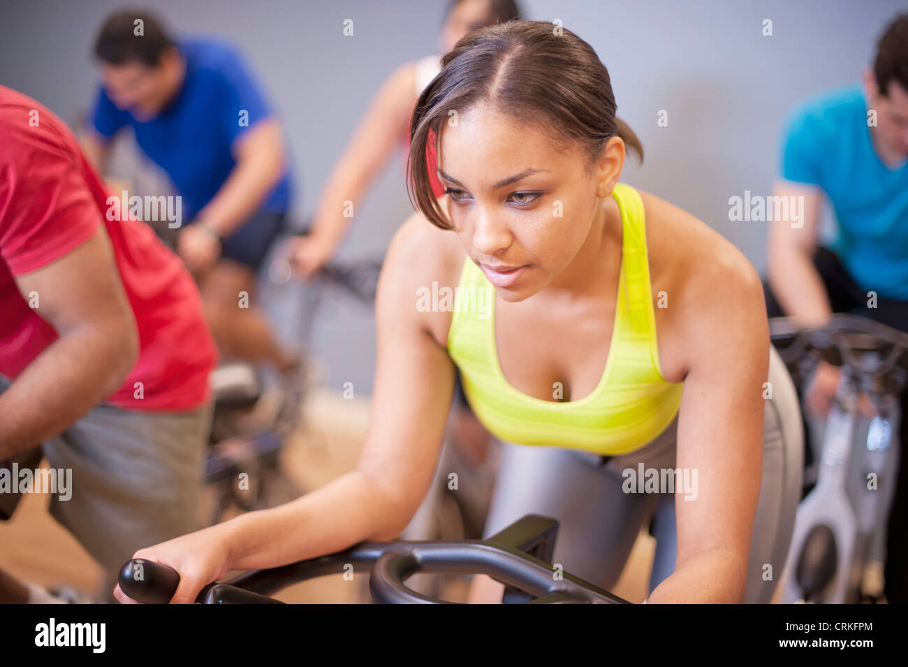 People using spin machines in gym Stock Photo - Alamy