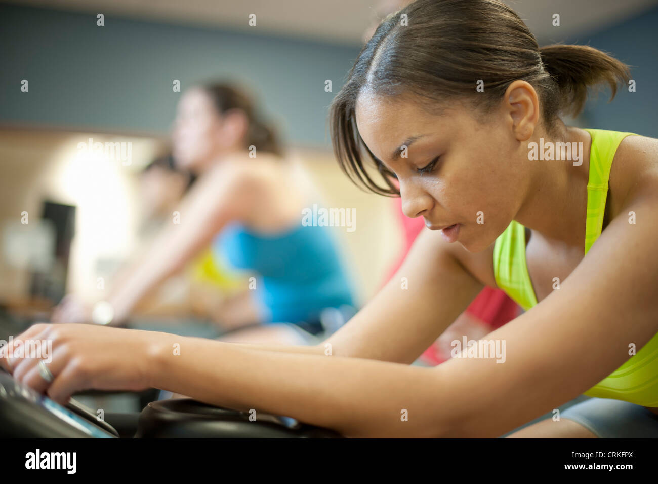 Woman using spin machine in gym Stock Photo - Alamy