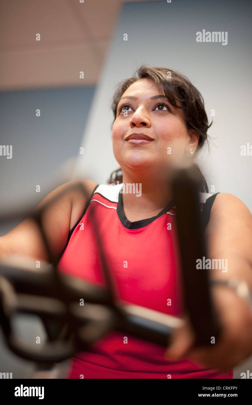 Woman using spin machine in gym Stock Photo - Alamy