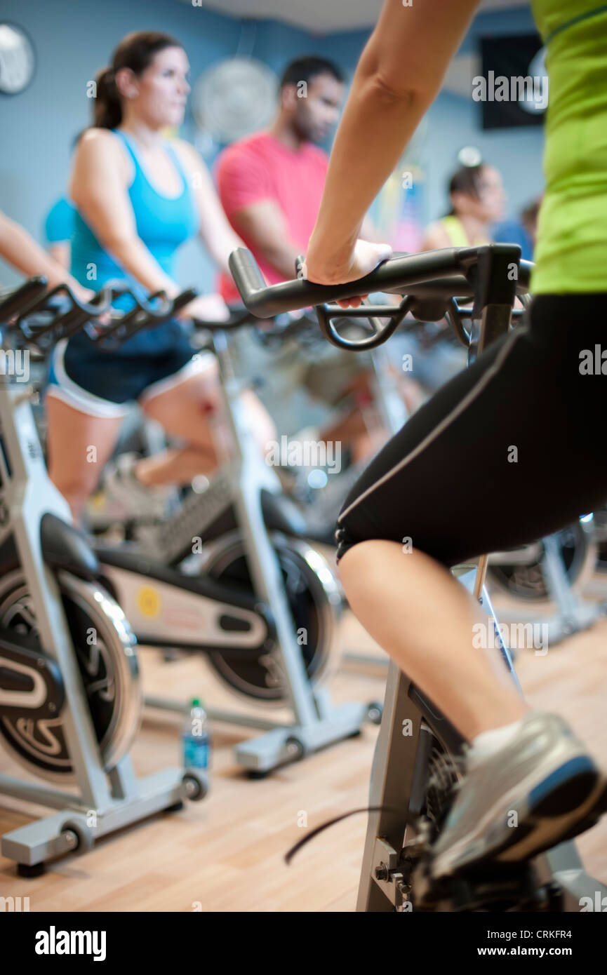 People using spin machines in gym Stock Photo - Alamy