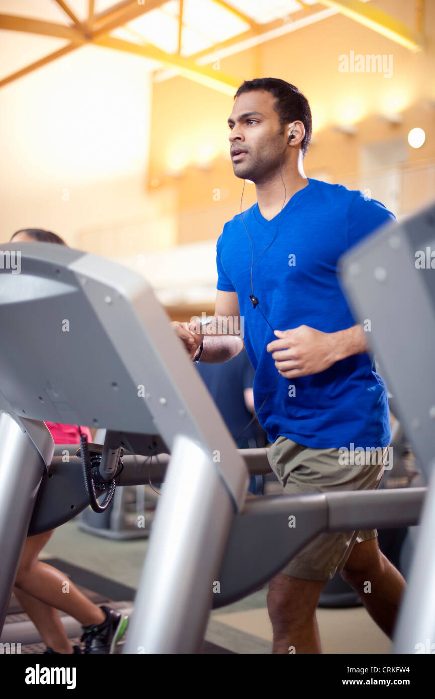 Man using treadmill in gym Stock Photo - Alamy
