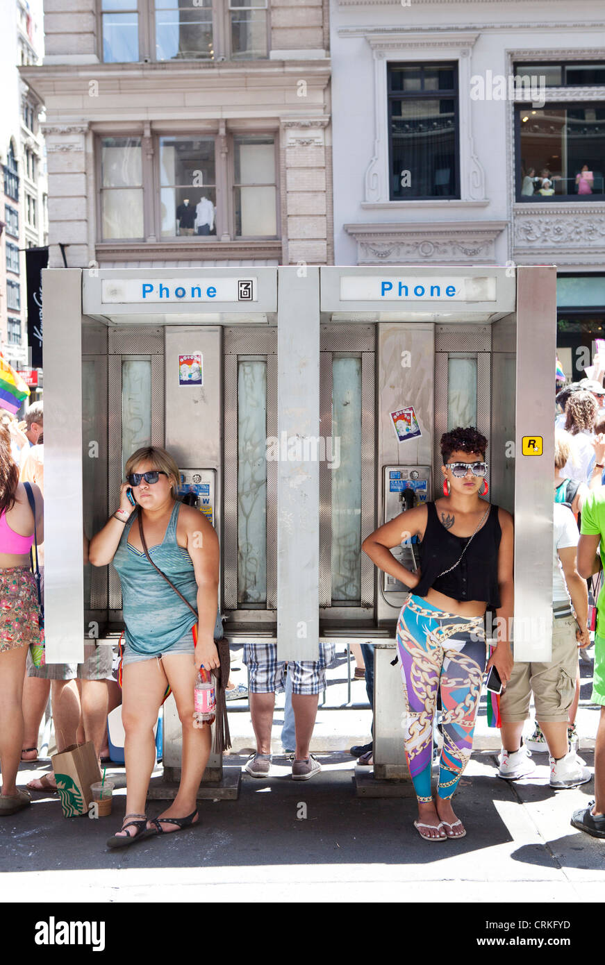 girls in pay phone box, New York Stock Photo - Alamy