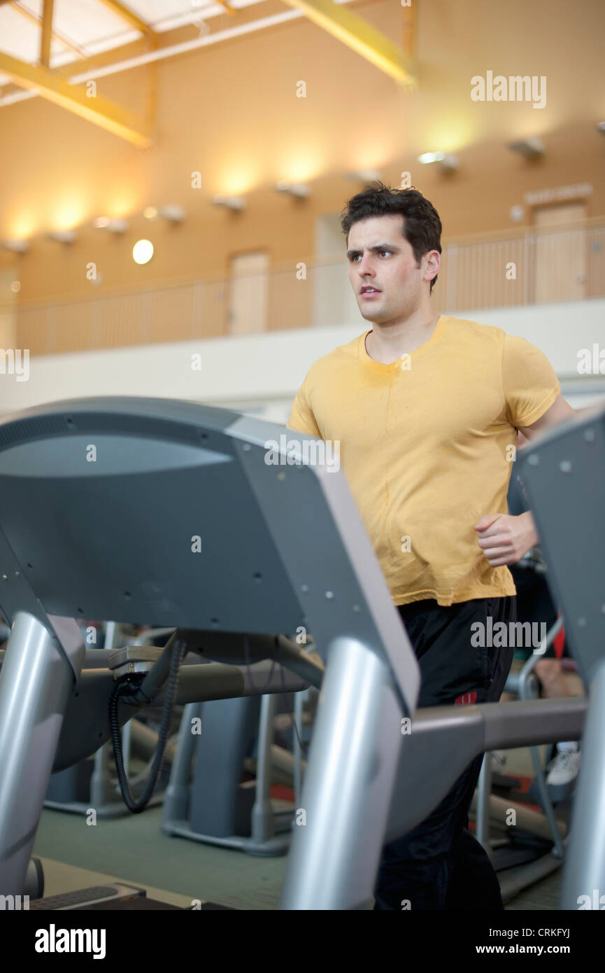 Man using treadmill in gym Stock Photo - Alamy
