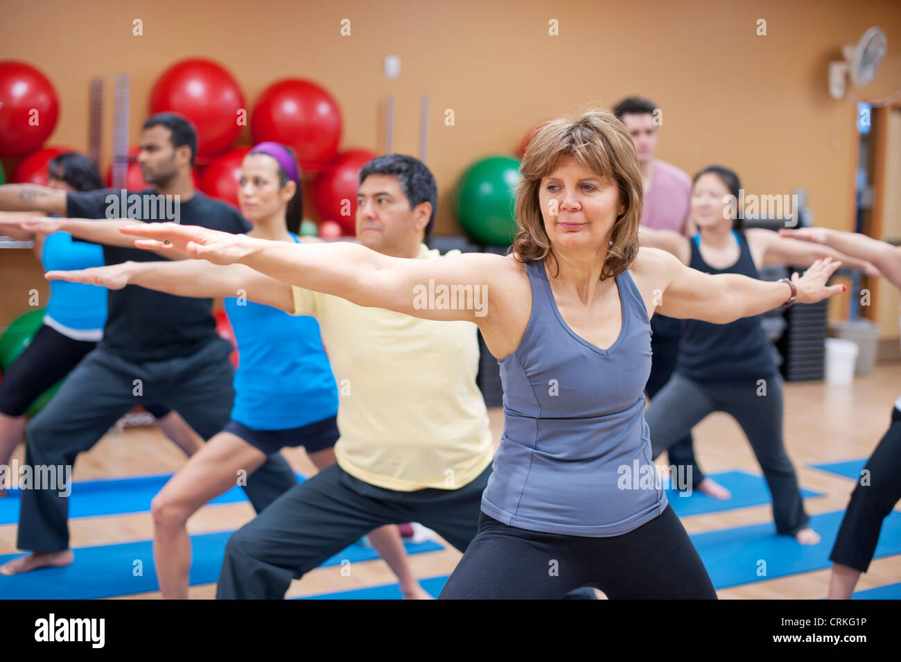 People practicing yoga in studio Stock Photo - Alamy