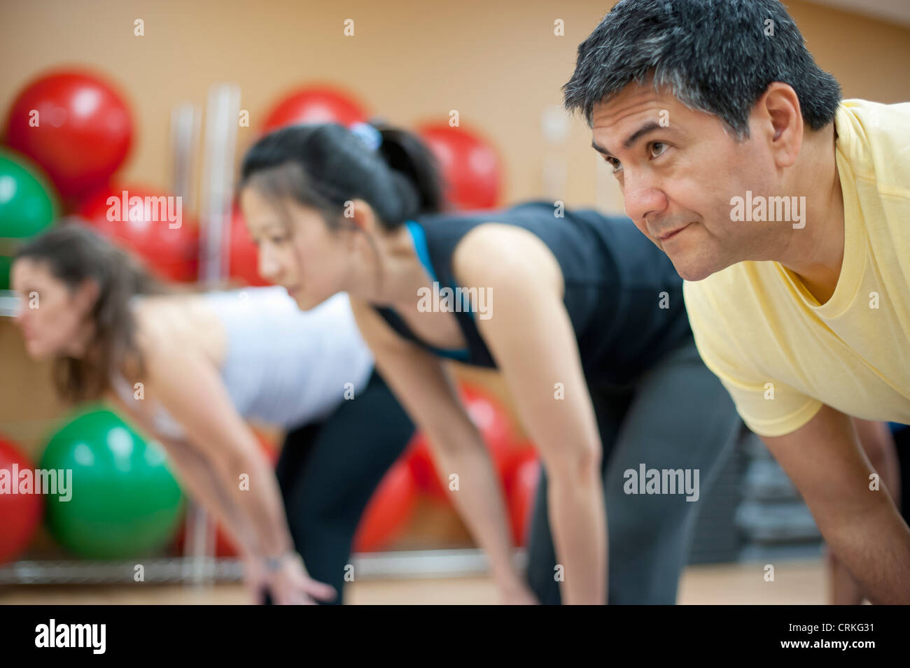 People practicing yoga in studio Stock Photo - Alamy