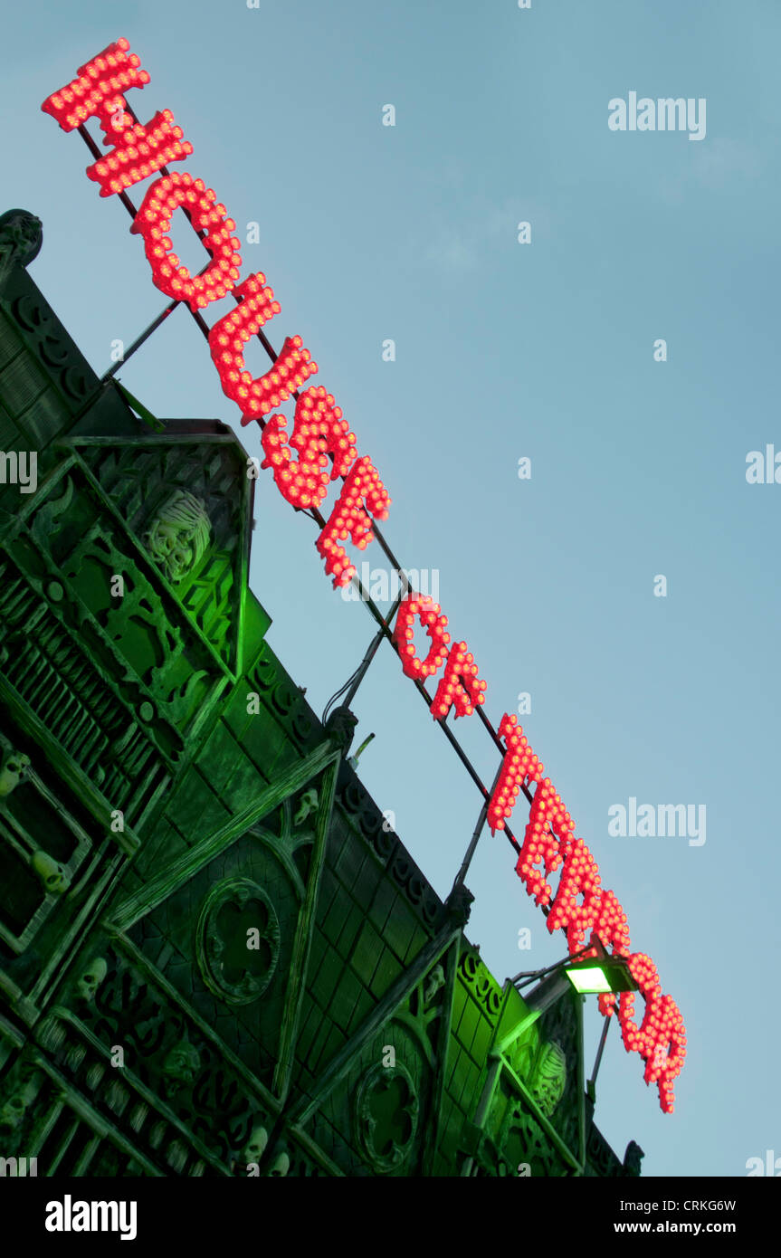 Sign above fairground ride or sideshow saying house of terror in red ...