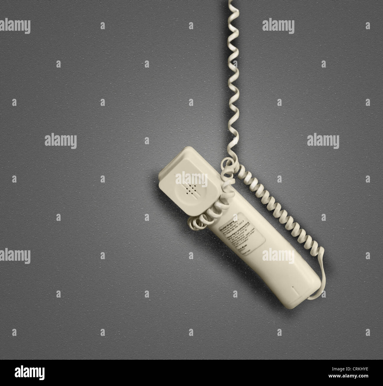 Hanging White Telephone Receiver on a Grey Background with Wire wrapped ...