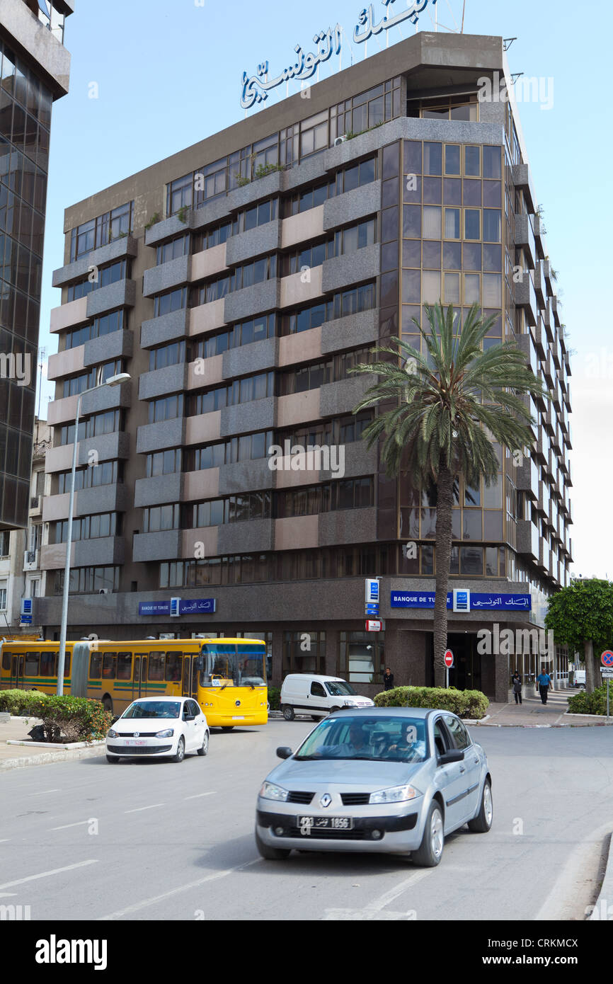 City public yellow bus on streets with modern buildings of capital ...