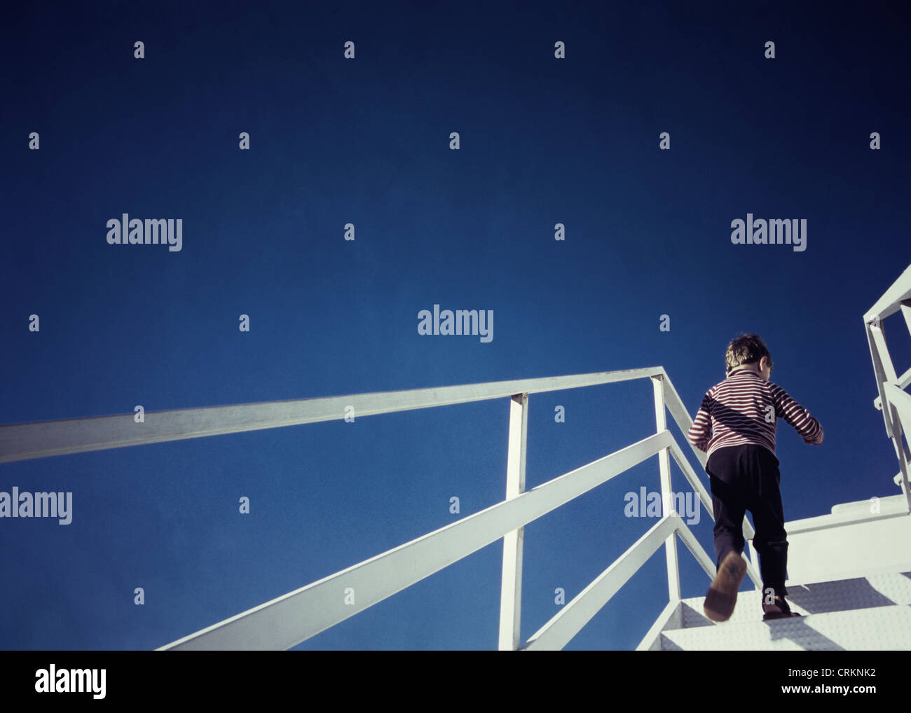 BOY RUNNING UP STAIRS Stock Photo - Alamy