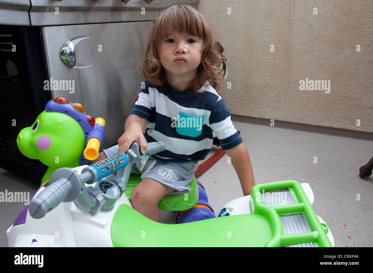 Little boy playing with toys Stock Photo - Alamy